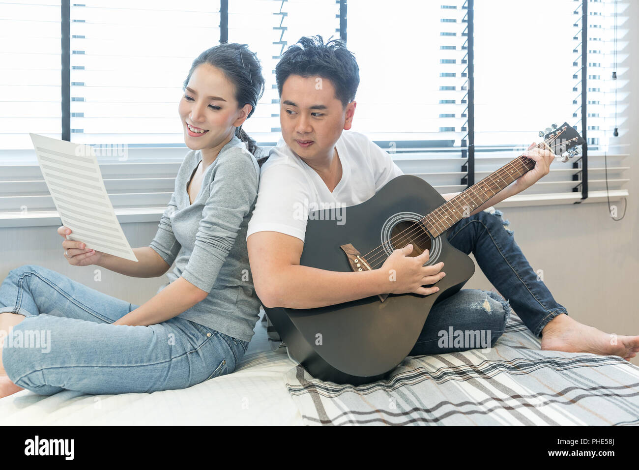 Young Couples playing guitar Stock Photo - Alamy