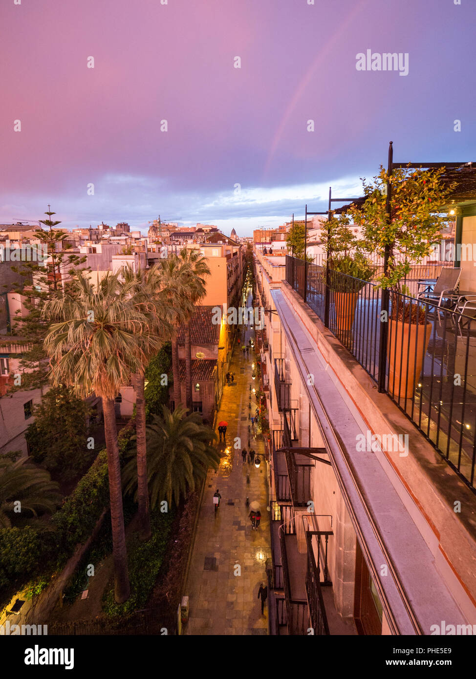 Rainbow over Barcelona sunset after rain, Spain from rooftop patio ...