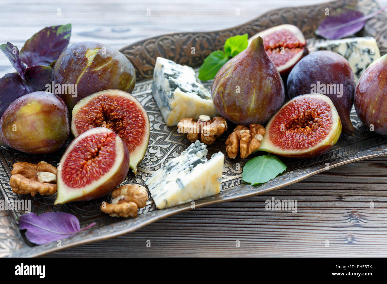 Blue cheese and ripe figs on a bronze tray Stock Photo - Alamy
