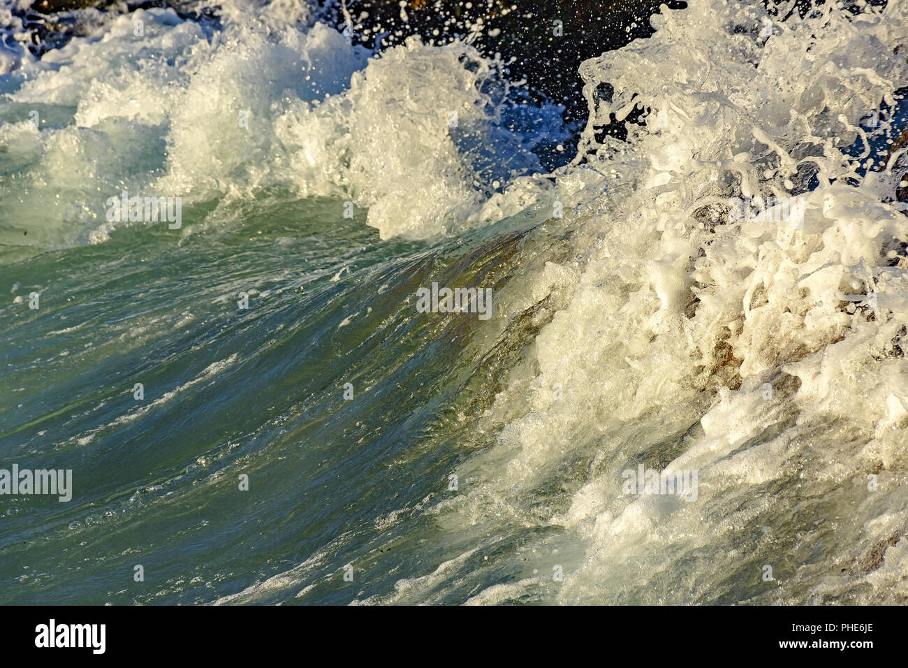 Wave foam and drops over stone Stock Photo - Alamy