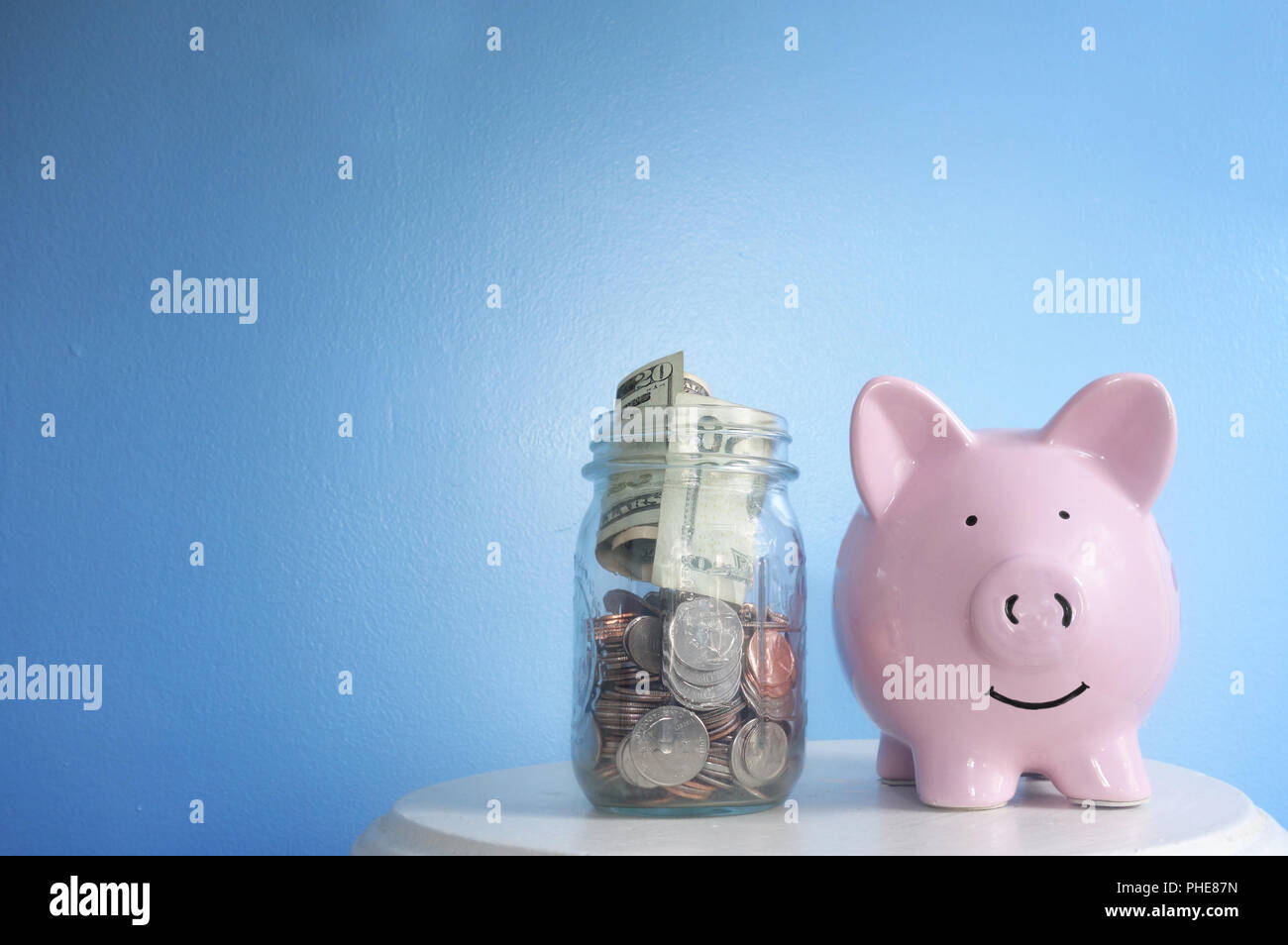 Happy piggy bank and coin jar Stock Photo - Alamy
