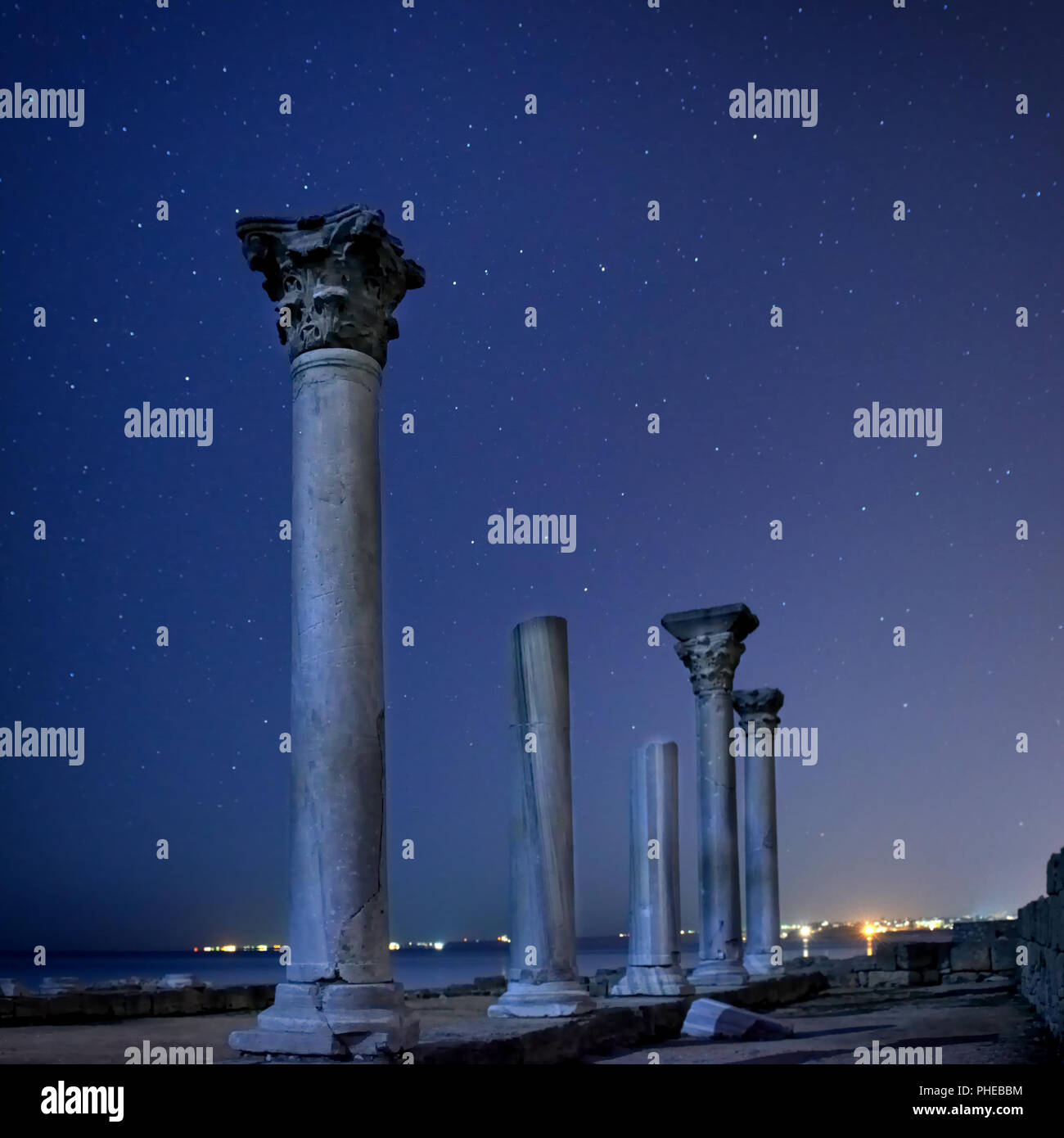 Ruins of ancient city columns under night sky Stock Photo - Alamy