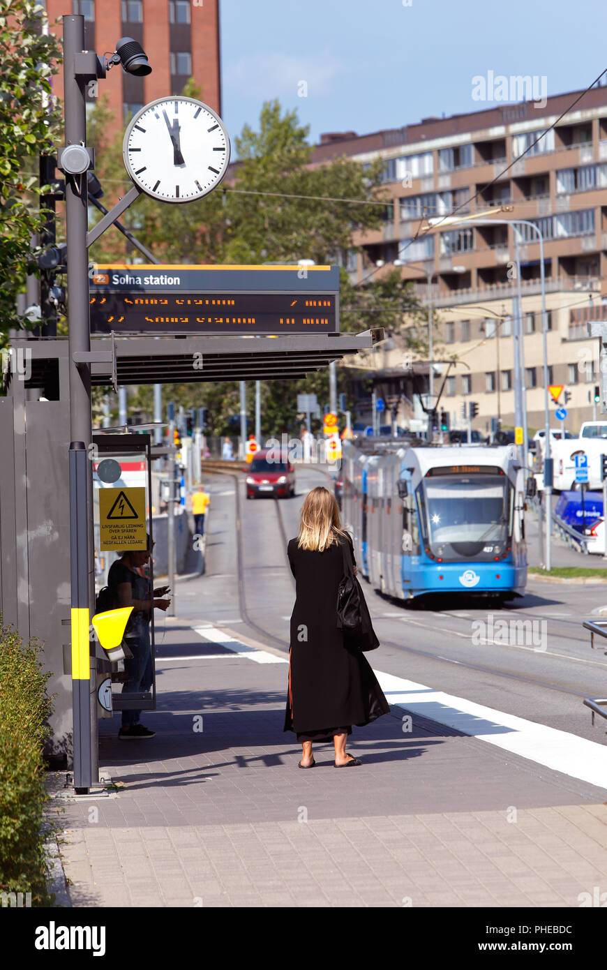 Woman waiting at bus stop hi-res stock photography and images - Alamy