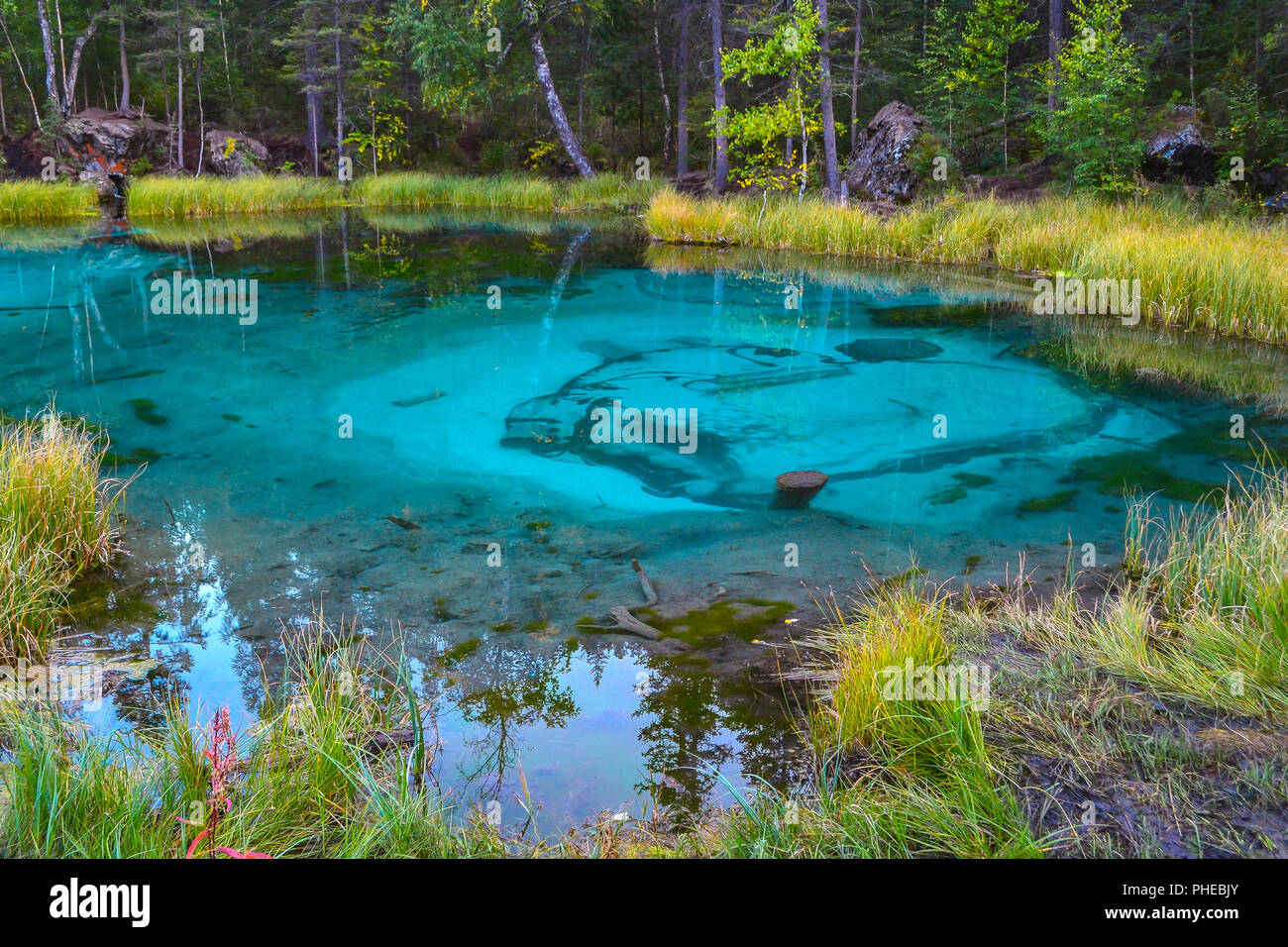 An unusual magical and mysterious geyser lake of turquoise color in ...