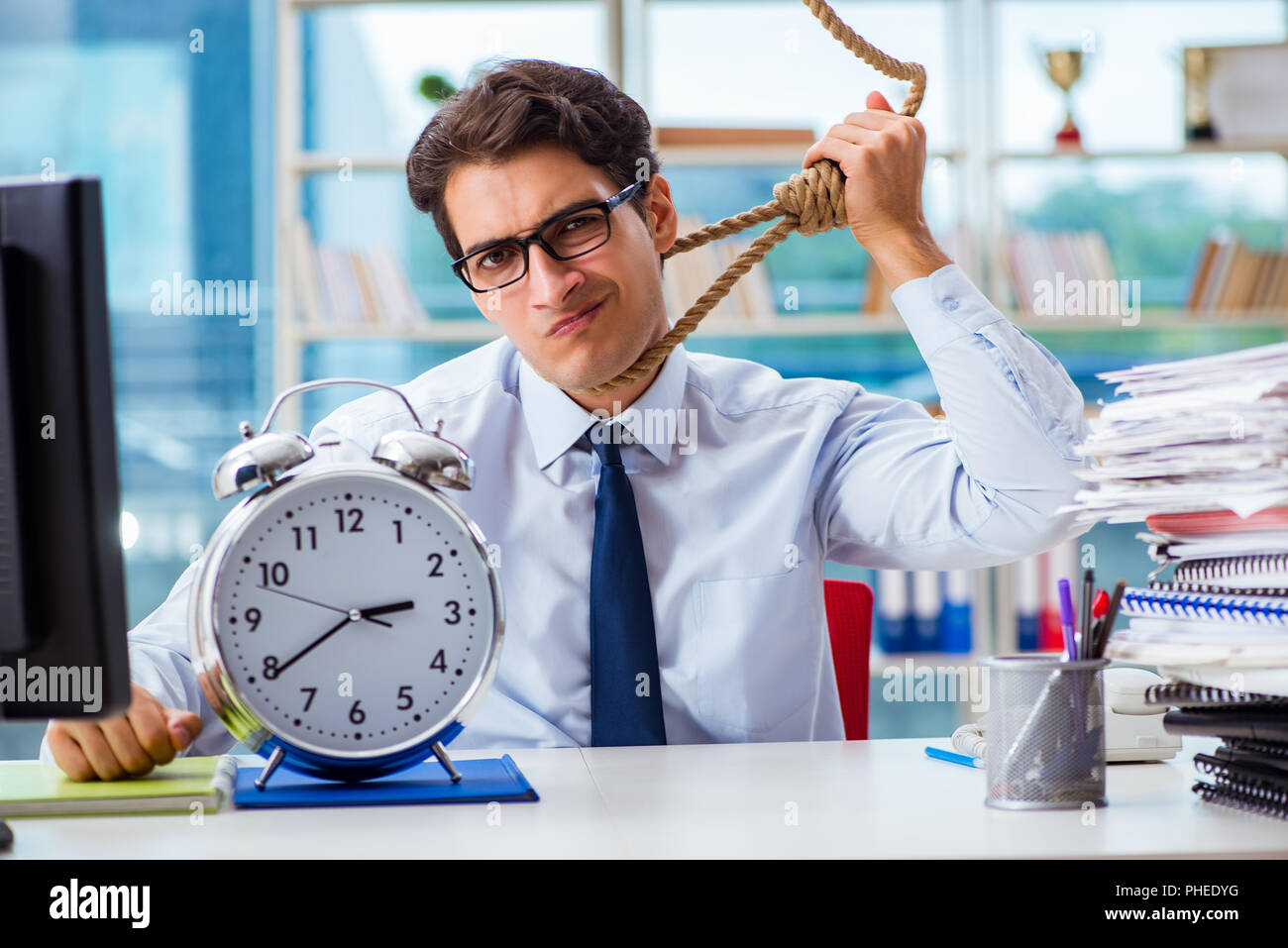 Unhappy businessman thinking of hanging himself in the office Stock ...