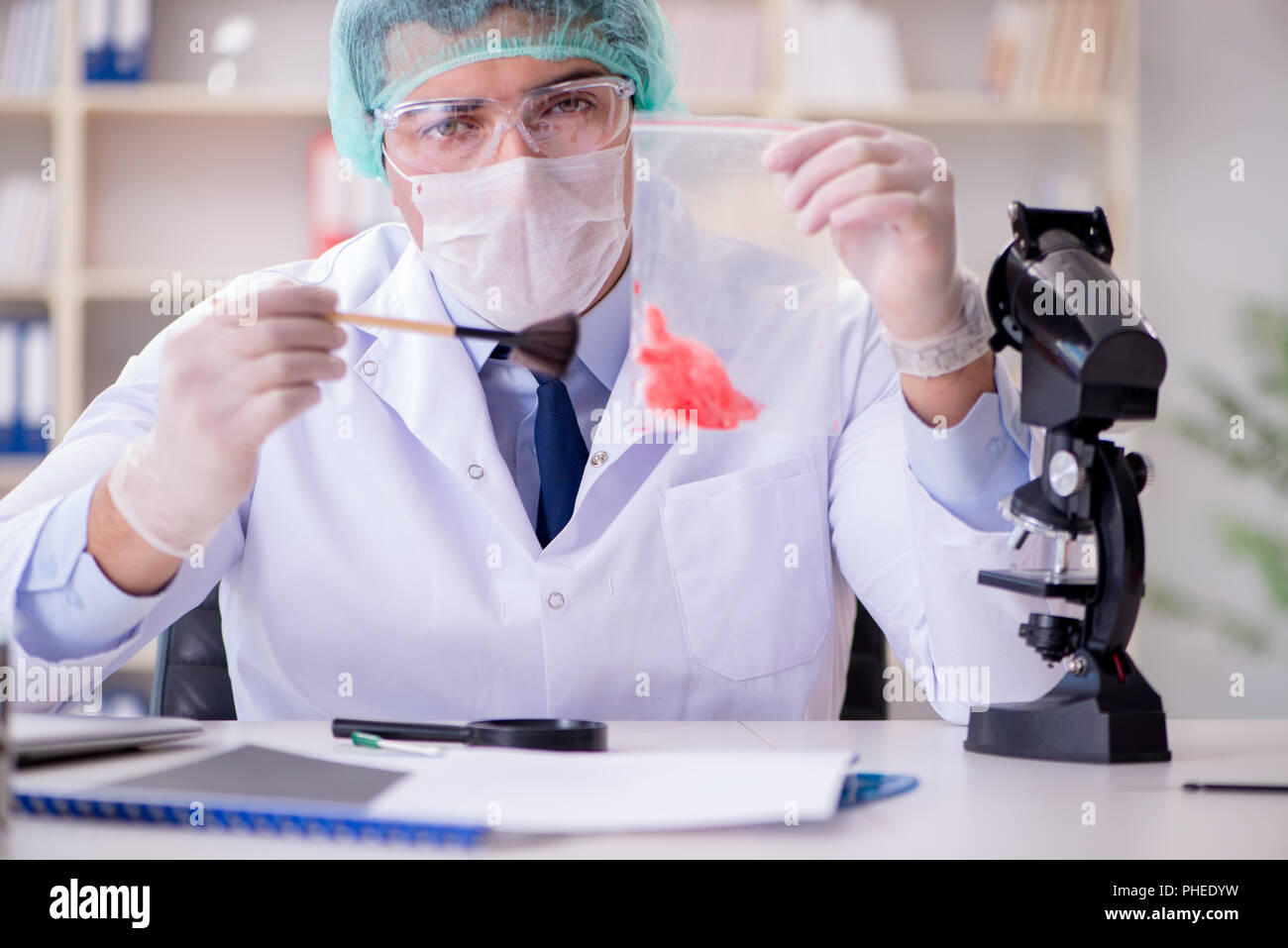 Forensics investigator working in lab on crime evidence Stock Photo - Alamy