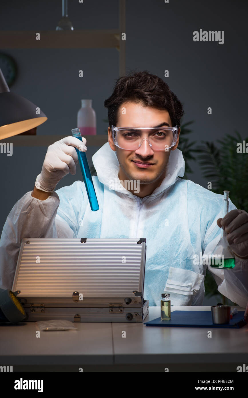 Forensic investigator working in lab looking for evidence Stock Photo ...