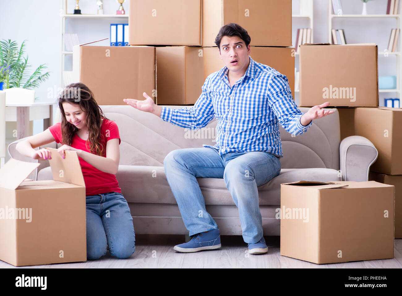 Young pair moving in to new house with boxes Stock Photo - Alamy