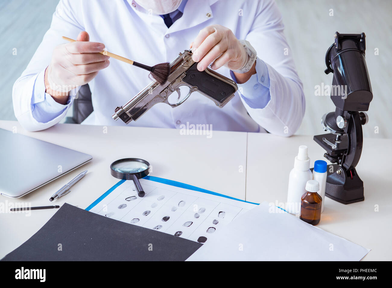 Criminologist police chemist looking at crime evidence Stock Photo - Alamy