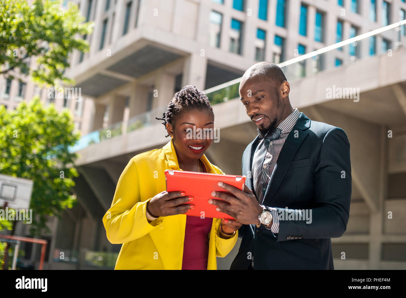 African happy people hold gadget at street urban background Stock Photo ...