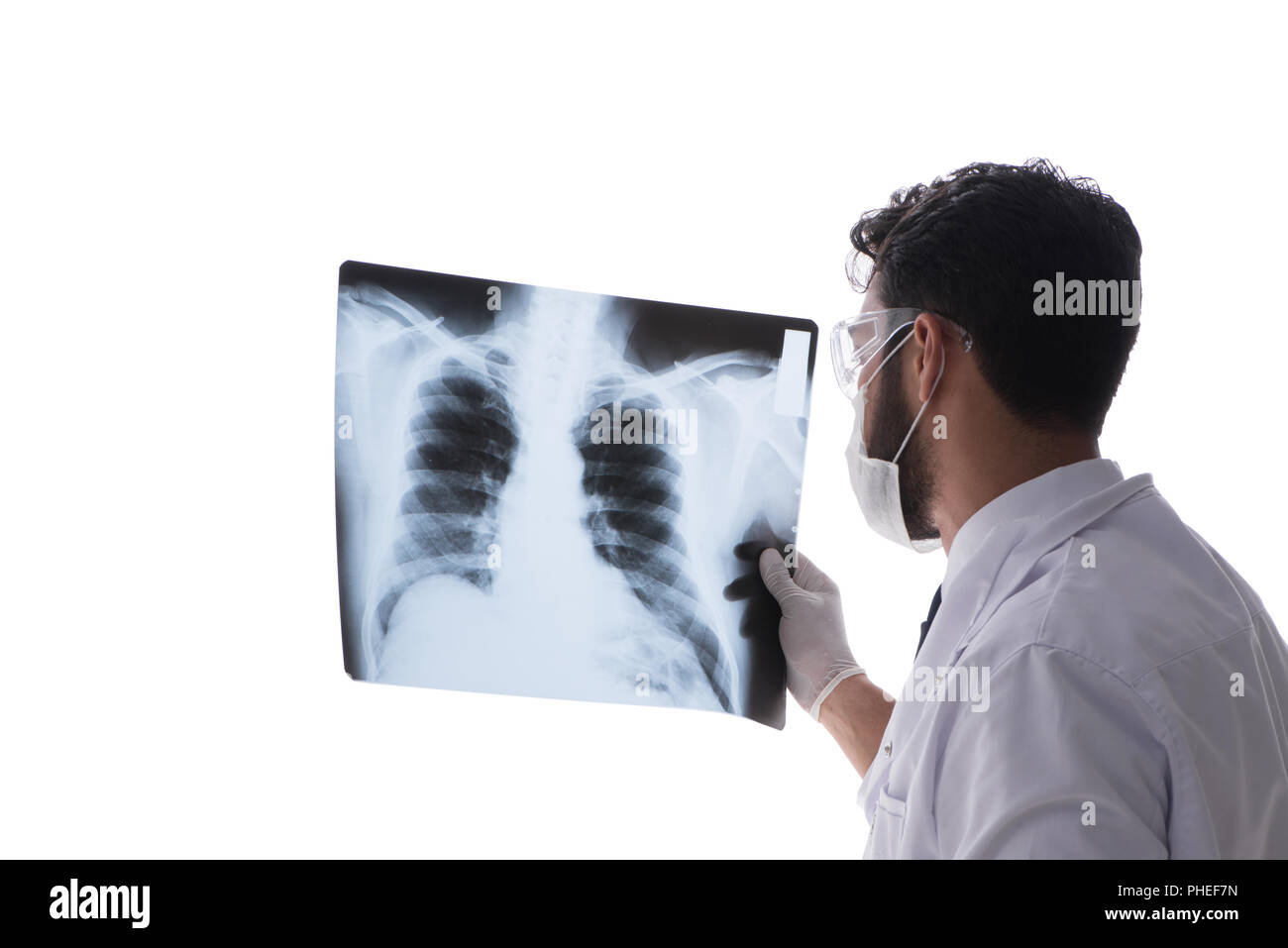 Young doctor looking at x-ray images isolated on white Stock Photo - Alamy