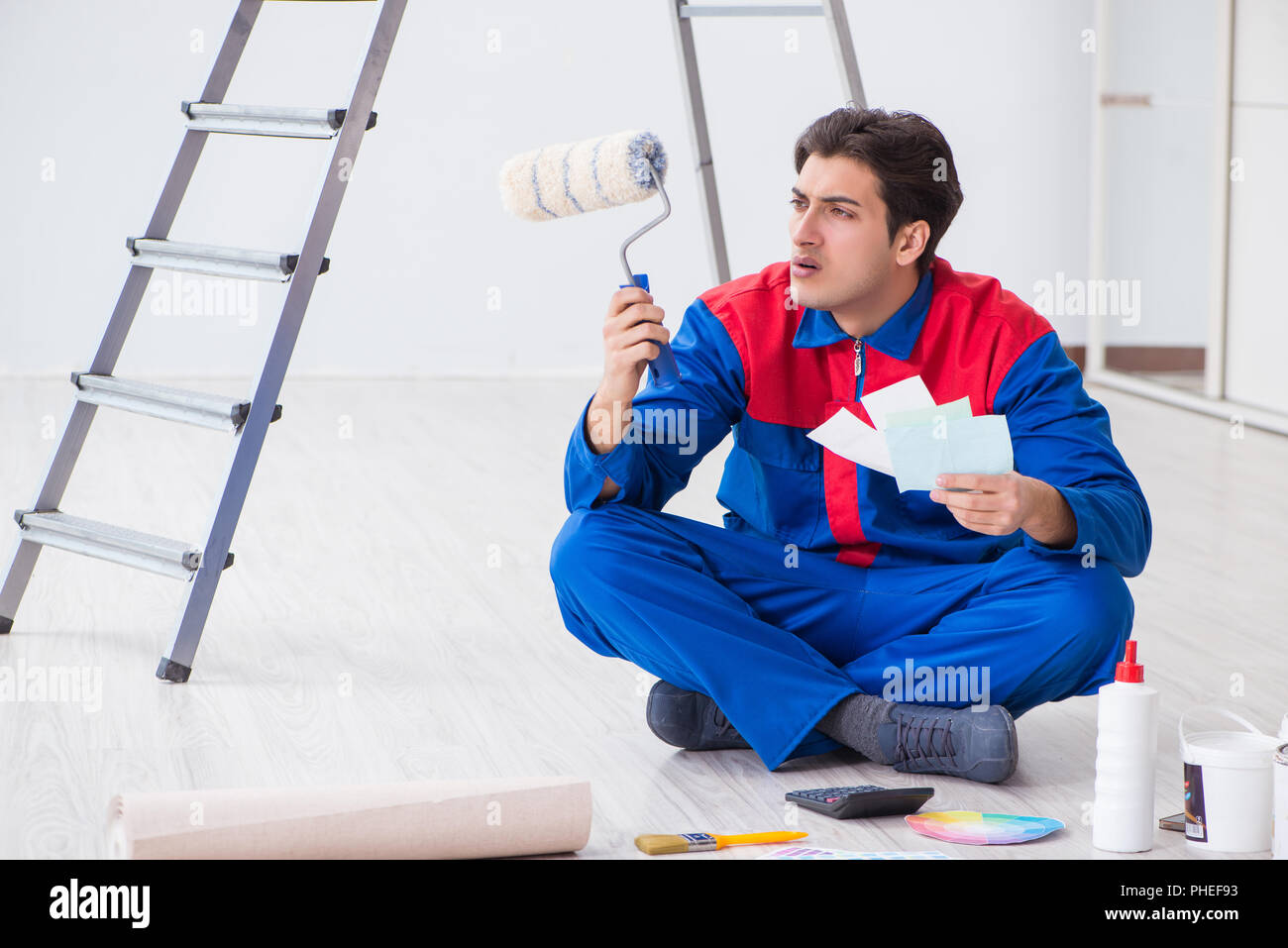 Young painter trying to match colours for painting job Stock Photo - Alamy