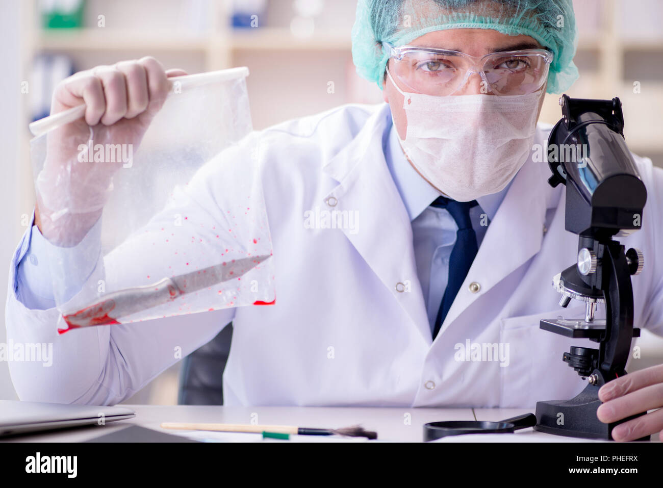 Forensics investigator working in lab on crime evidence Stock Photo - Alamy
