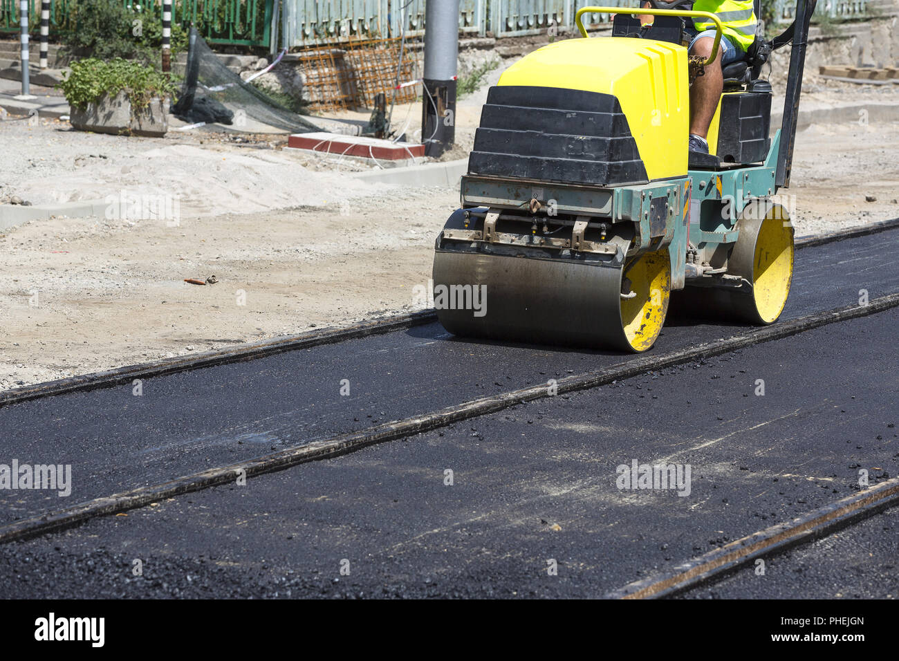 Steamroller construct asphalt road and railroad lines Stock Photo - Alamy