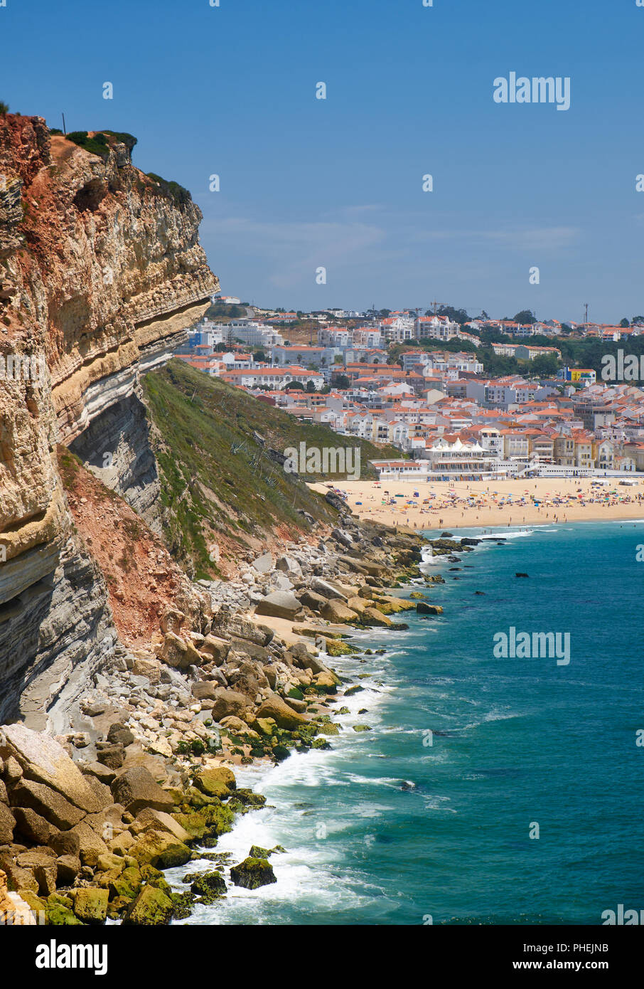 Rocks between Farol De Nazare and Nazare beach and town Stock Photo - Alamy