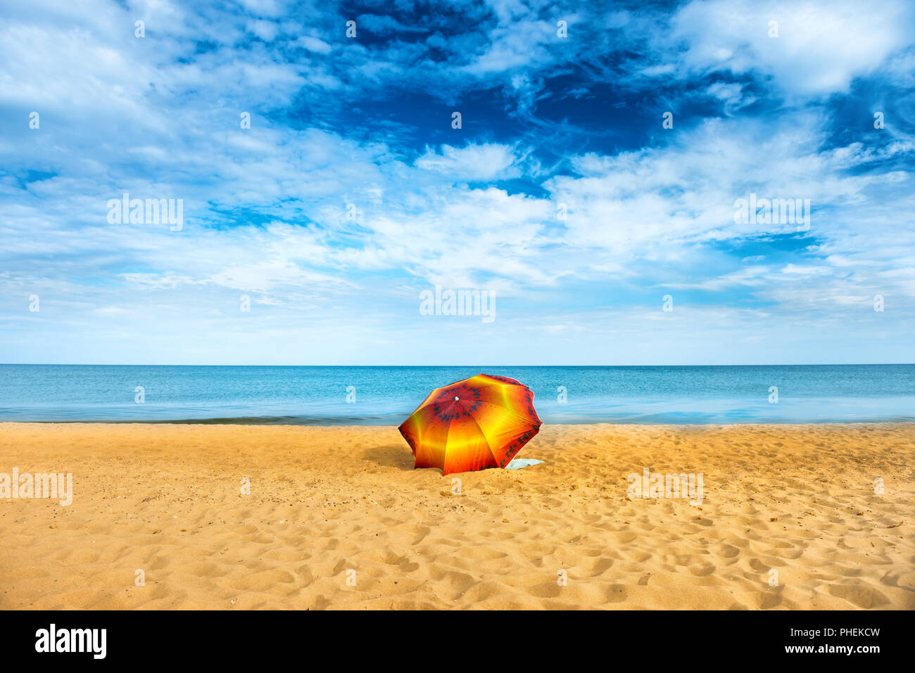 Umbrella on golden sand beach Stock Photo - Alamy