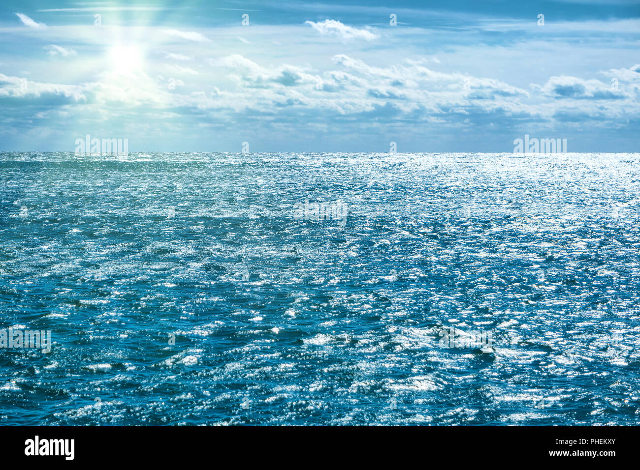 Blue sea with sky and clouds Stock Photo - Alamy