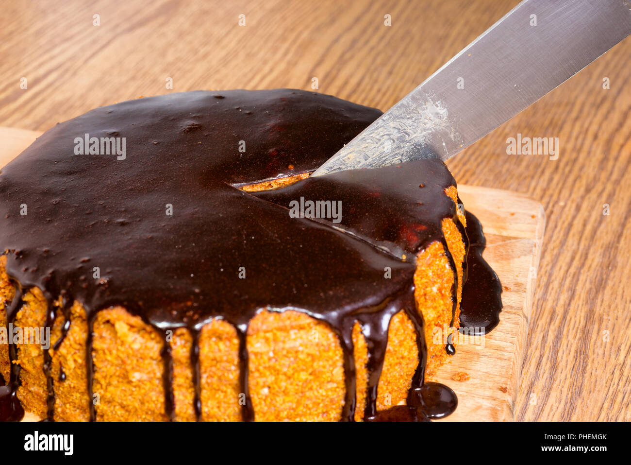 Sliced by knife chocolate birthday cake Stock Photo - Alamy