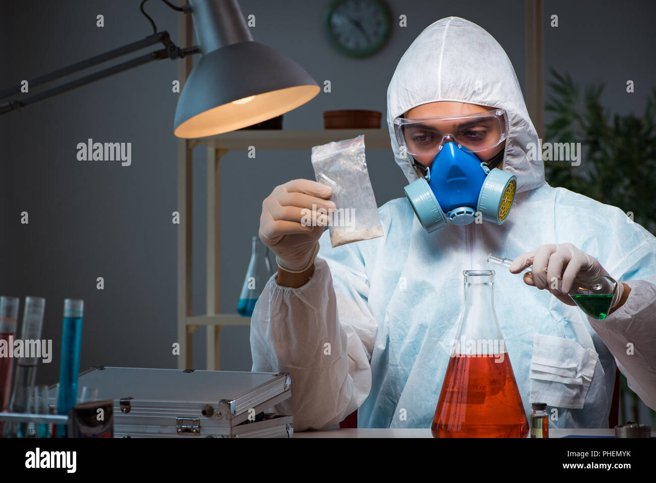 Forensic investigator working in lab looking for evidence Stock Photo ...