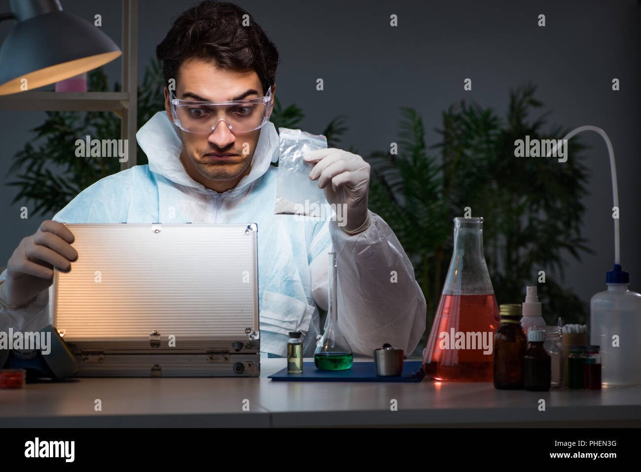 Forensic investigator working in lab looking for evidence Stock Photo ...