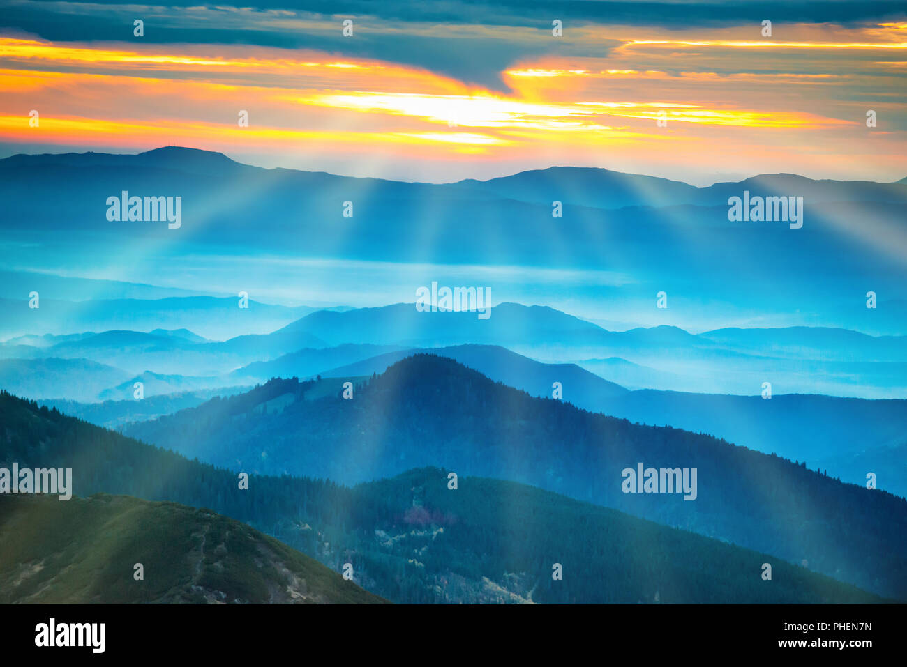 Blue mountains and hills under sunset Stock Photo - Alamy