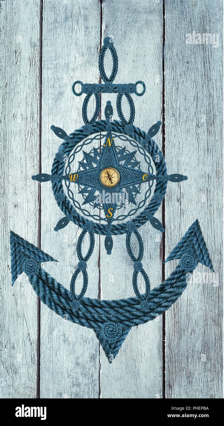 Compass anchor wheel on wood Stock Photo - Alamy