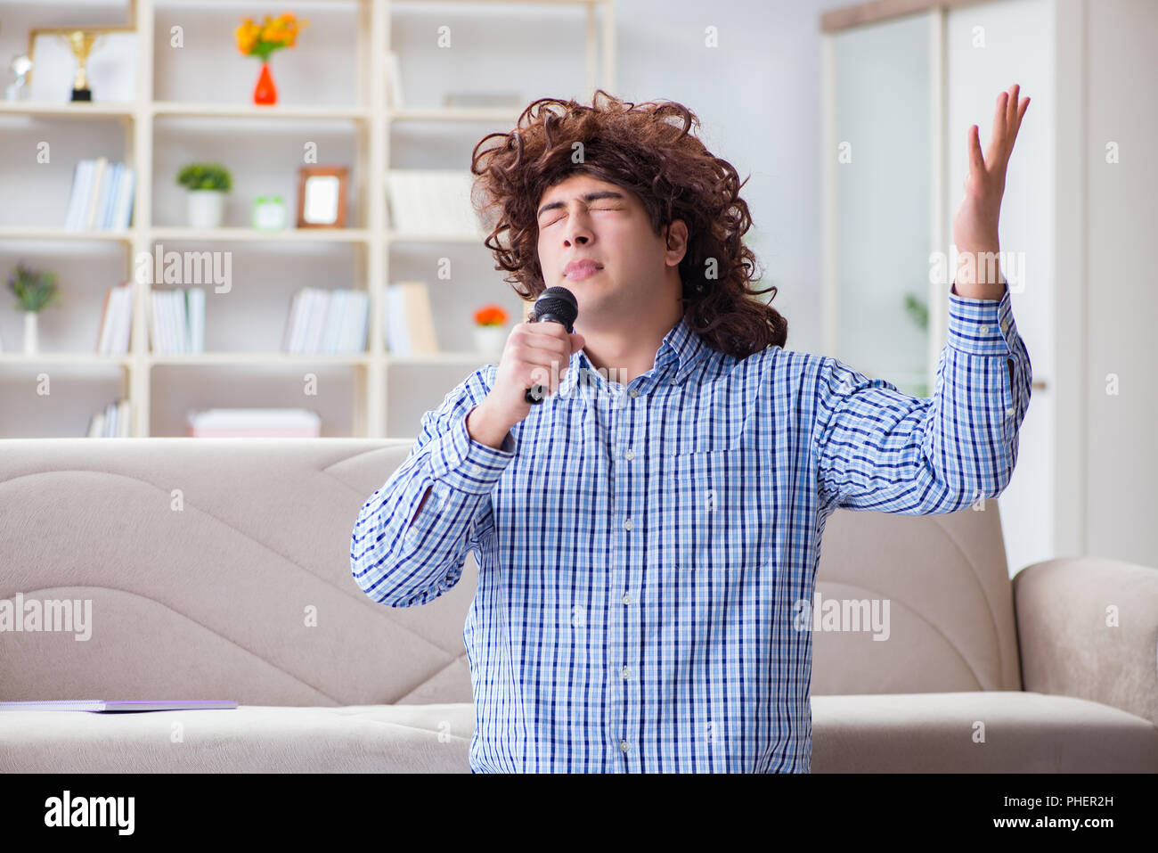 Funny man singing songs in karaoke at home Stock Photo - Alamy