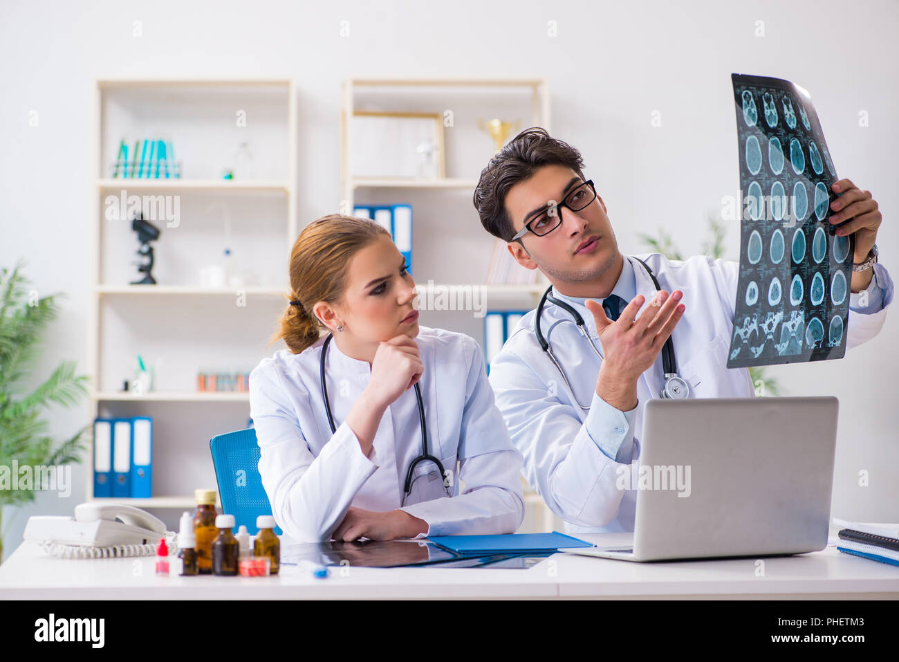 Two doctors examining x-ray images of patient for diagnosis Stock Photo ...