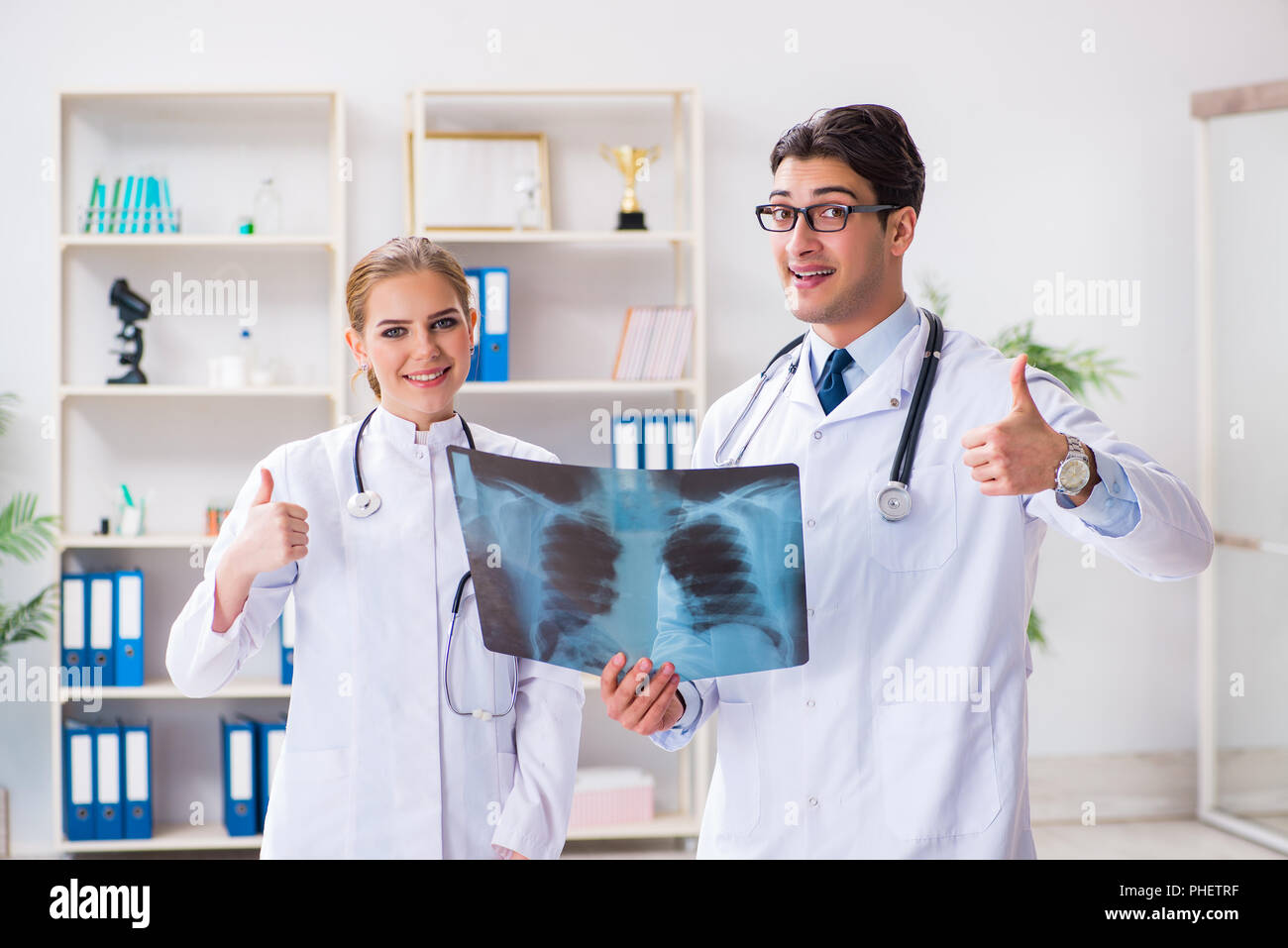 Two doctors examining x-ray images of patient for diagnosis Stock Photo ...