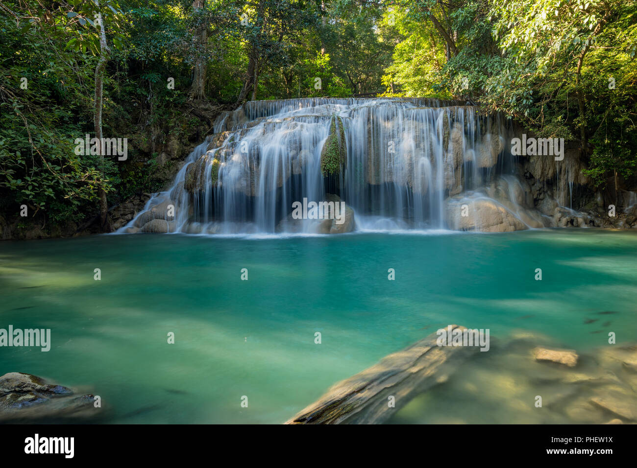 Erawan Waterfall with fish in water Stock Photo - Alamy