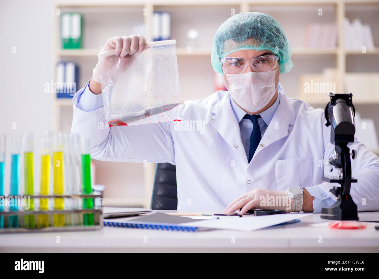 Forensics investigator working in lab on crime evidence Stock Photo - Alamy