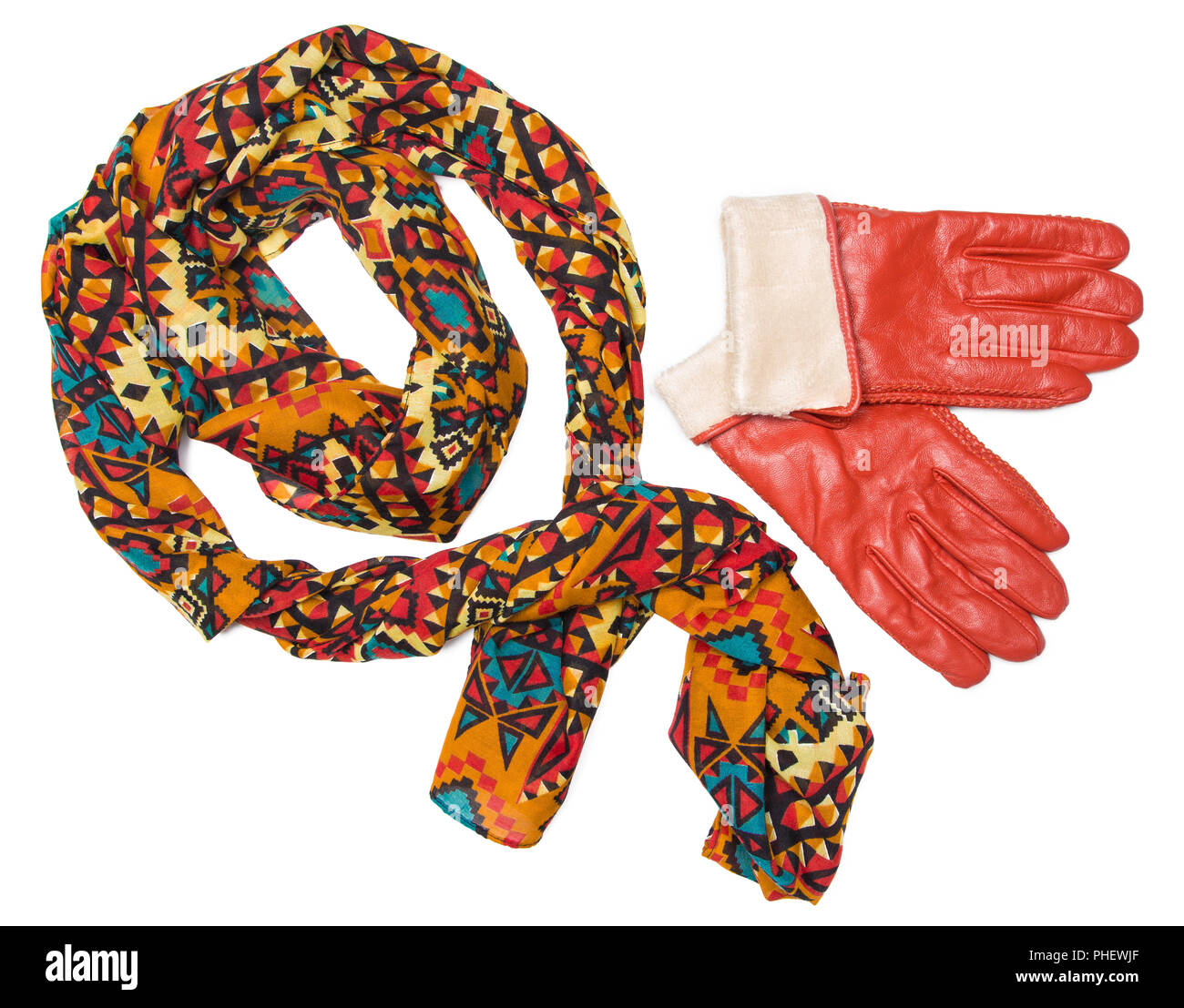 Bright patterned female scarf and orange leather gloves isolated on ...