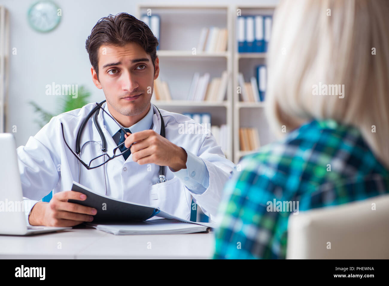 Patient visiting doctor for medical check-up in hospital Stock Photo ...