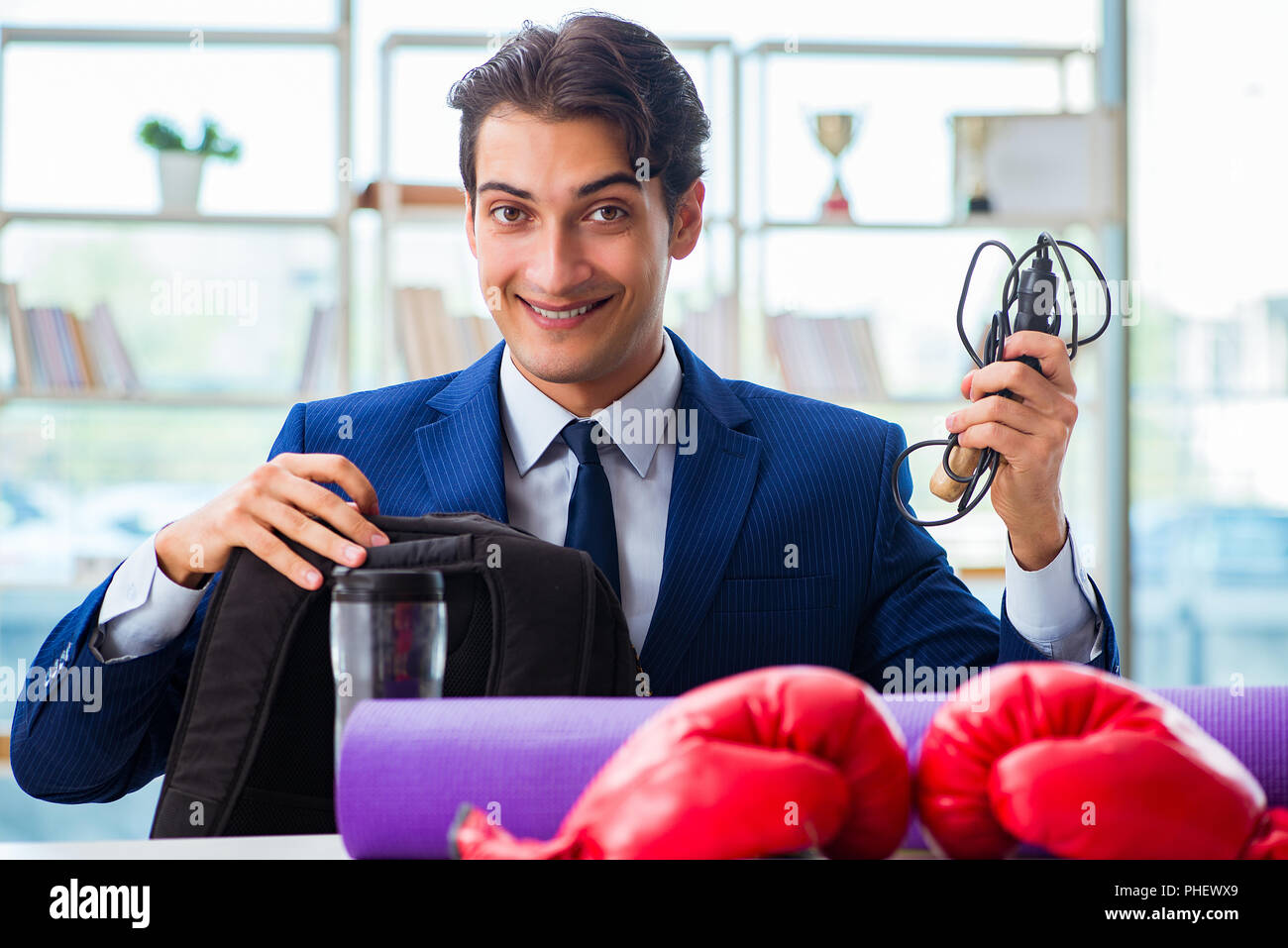 Man with boxing gloves in the office Stock Photo - Alamy