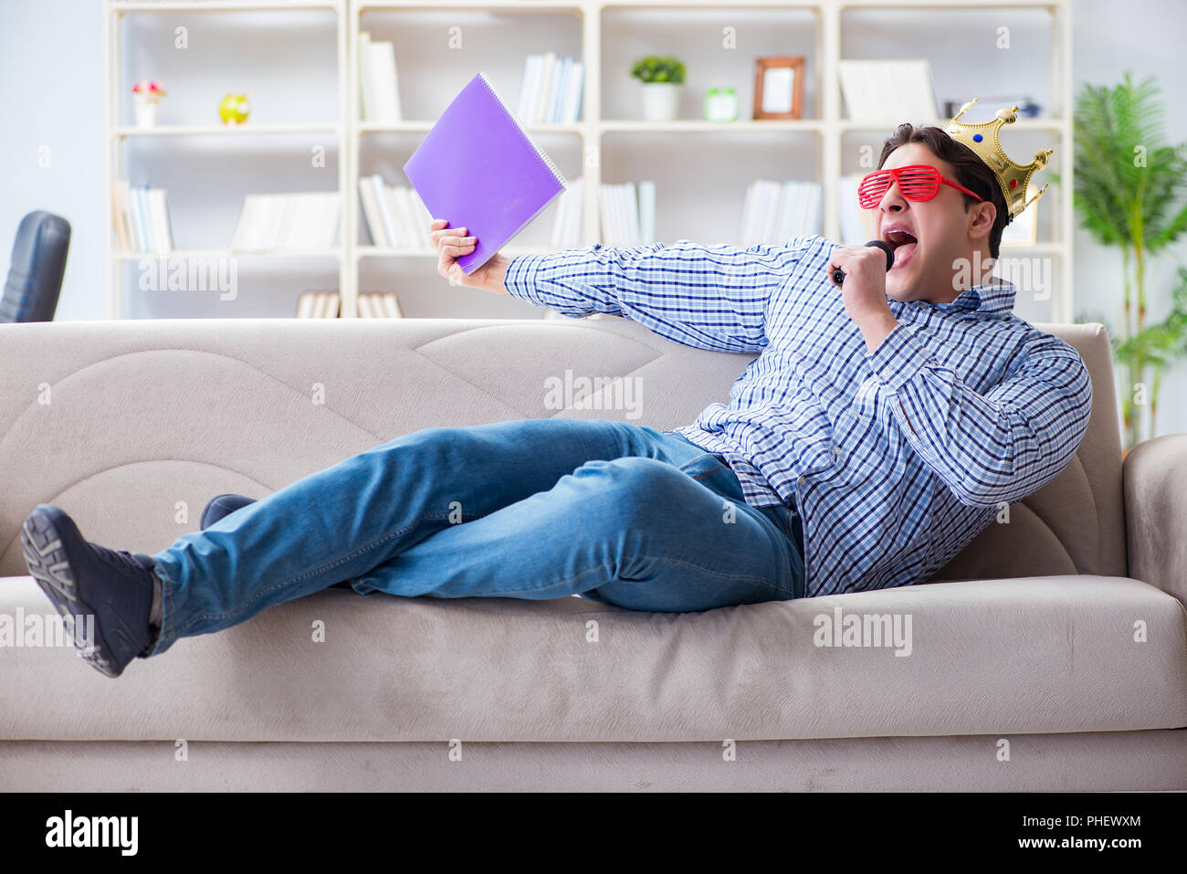 Funny man singing songs in karaoke at home Stock Photo - Alamy