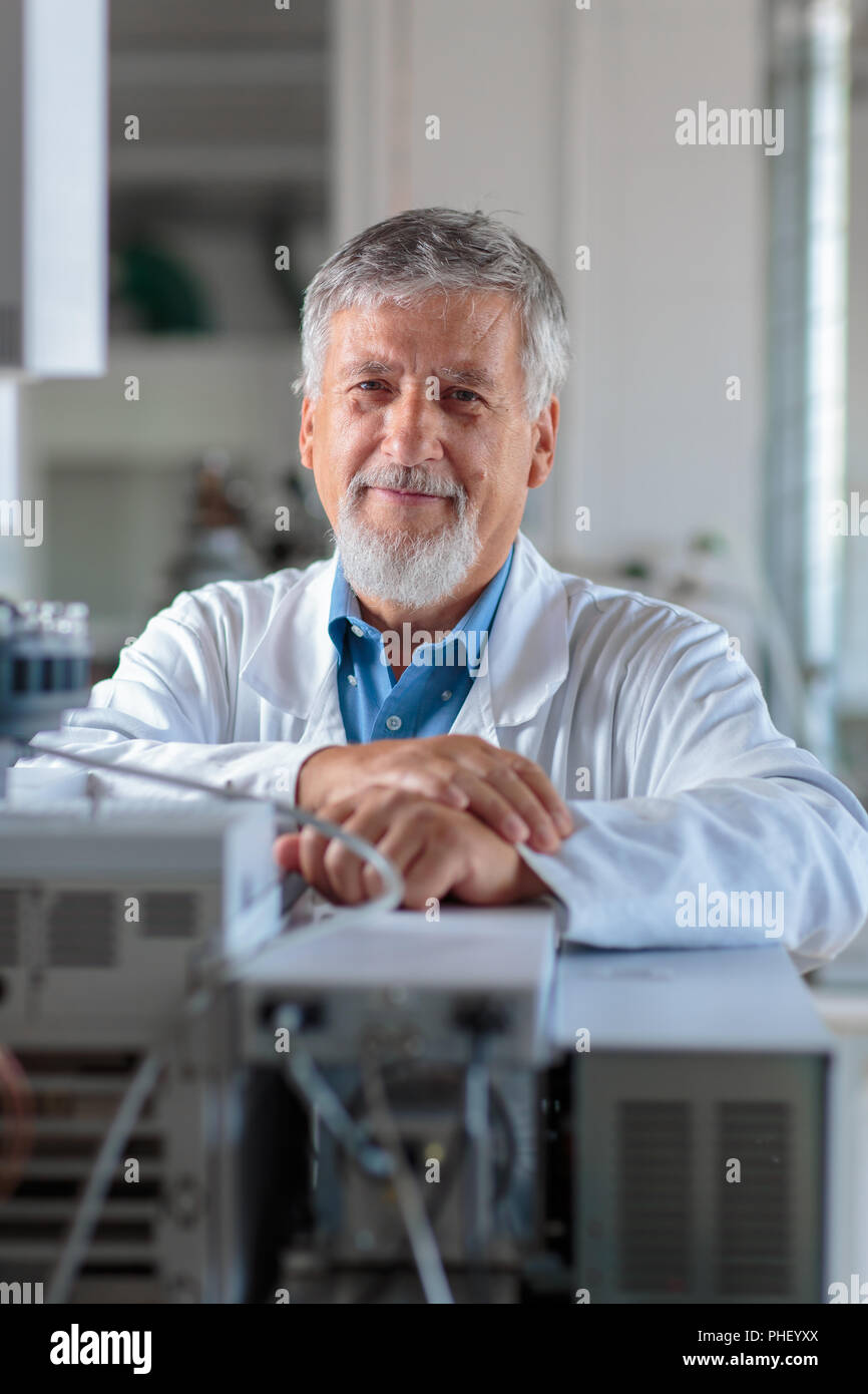 Senior chemistry professor/doctor carrying out research experiments in ...