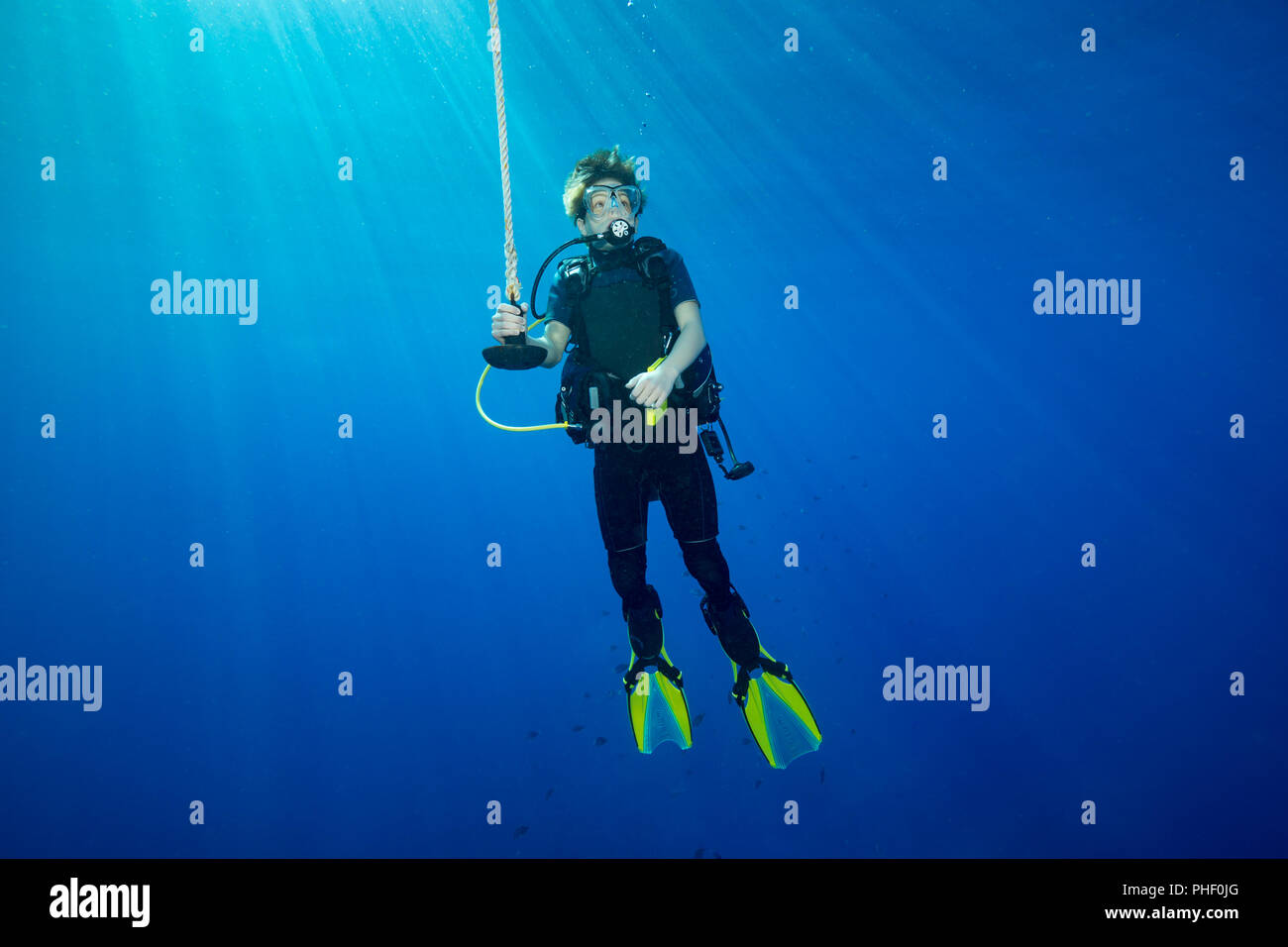 A diver (MR) pictured hanging on a line at 15 feet for a decompression ...