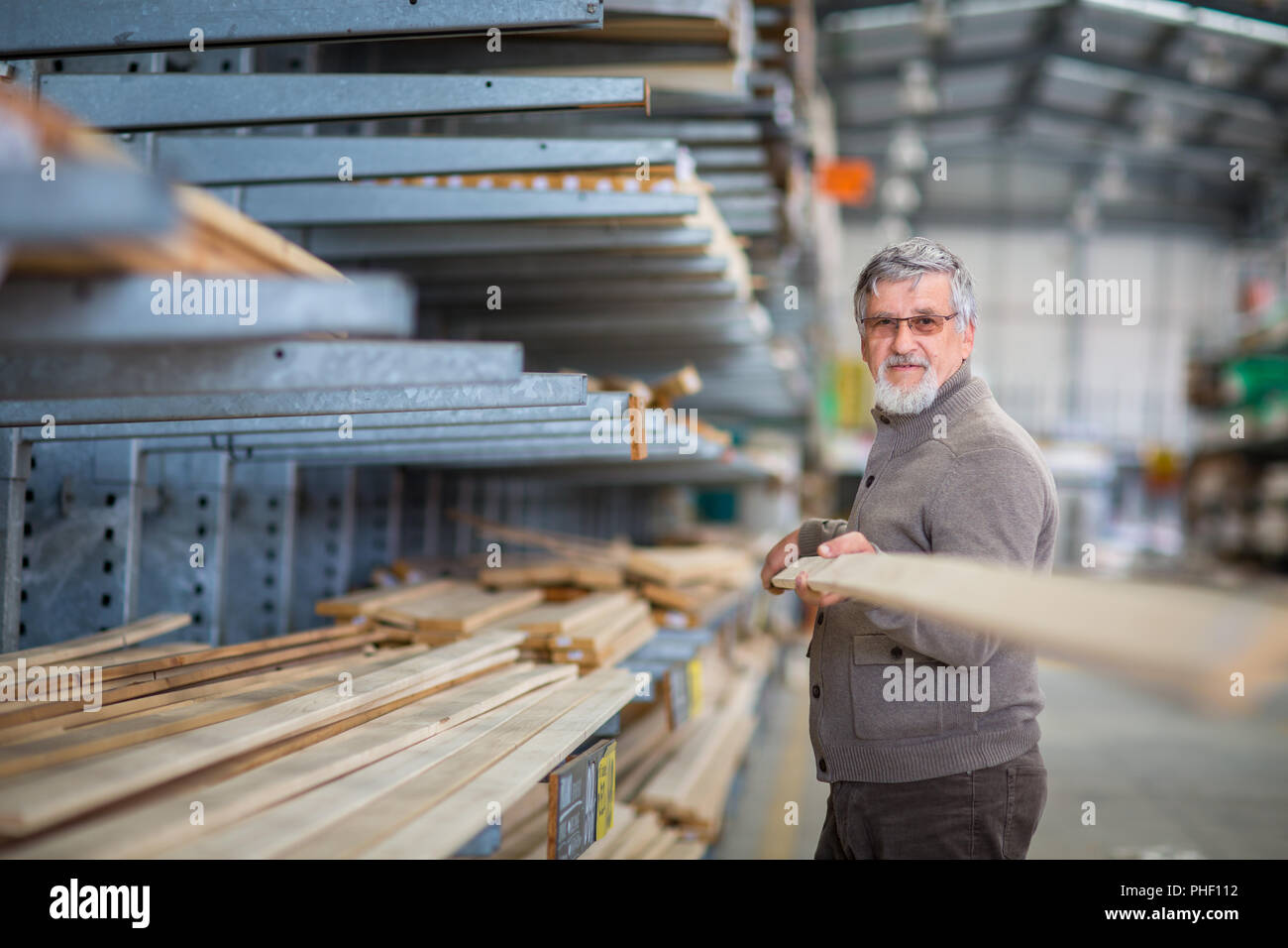 DIY concept -Senior man choosing and buying construction wood in a DIY ...