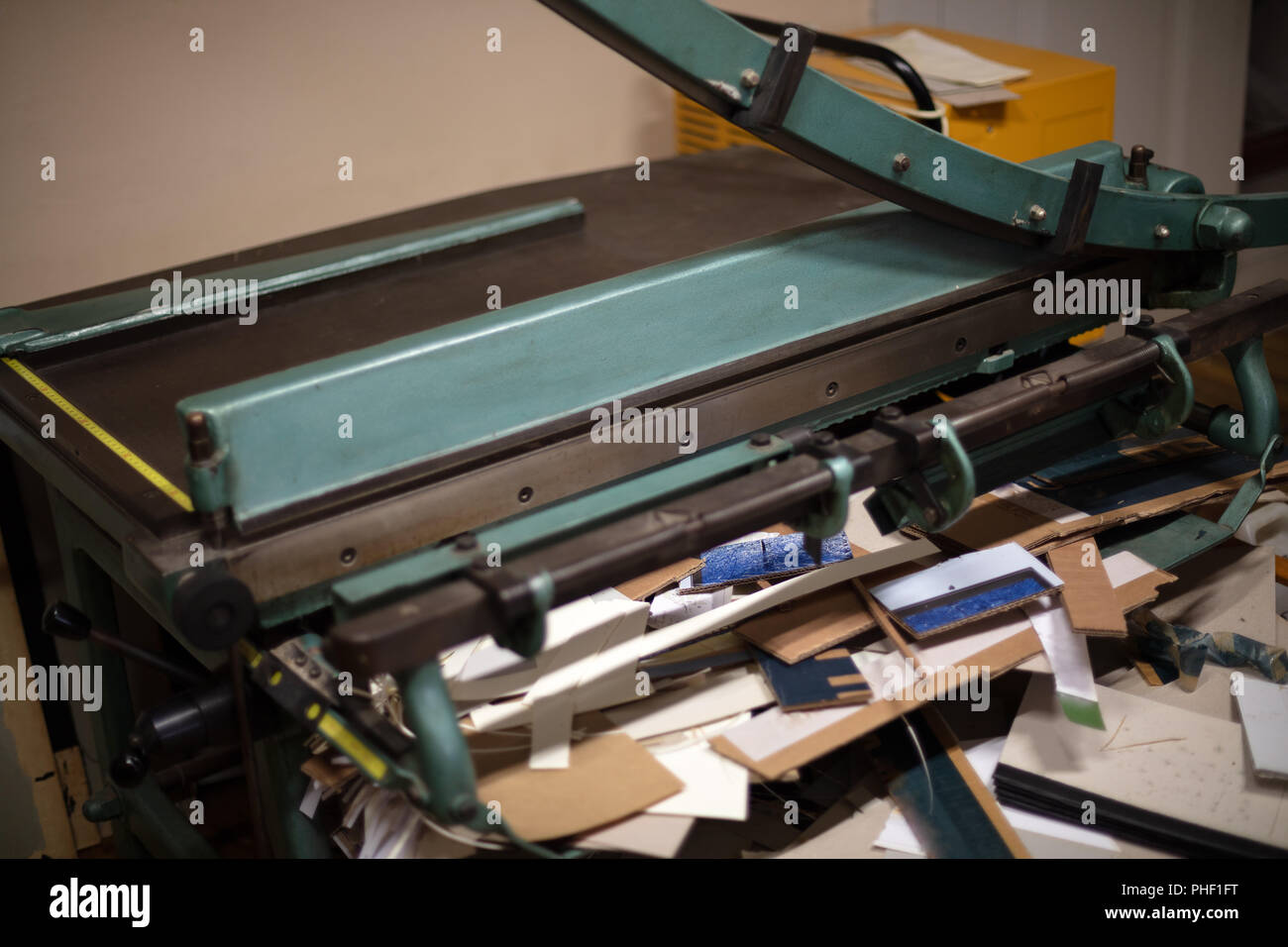Large guillotine for cutting paper with the blade raised in a low angle ...