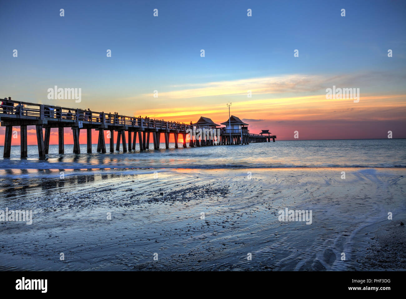 Naples Pier on the beach at sunset Stock Photo - Alamy