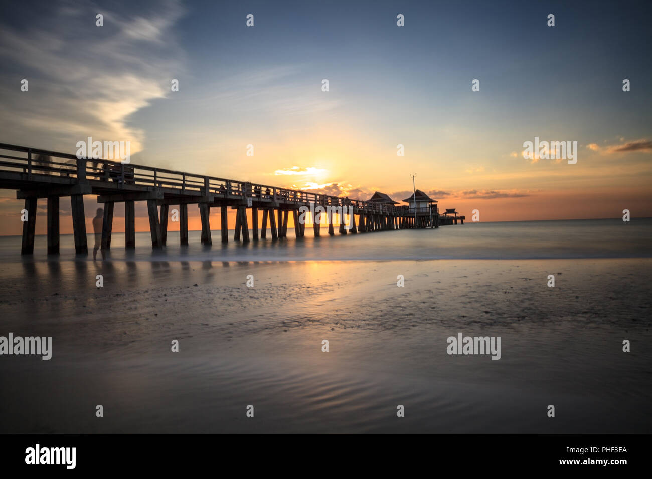 Naples Pier on the beach at sunset Stock Photo - Alamy