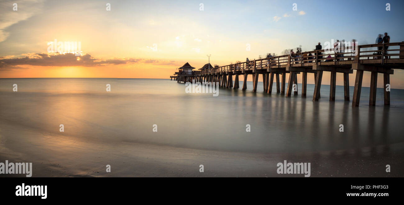 Naples Pier on the beach at sunset Stock Photo - Alamy