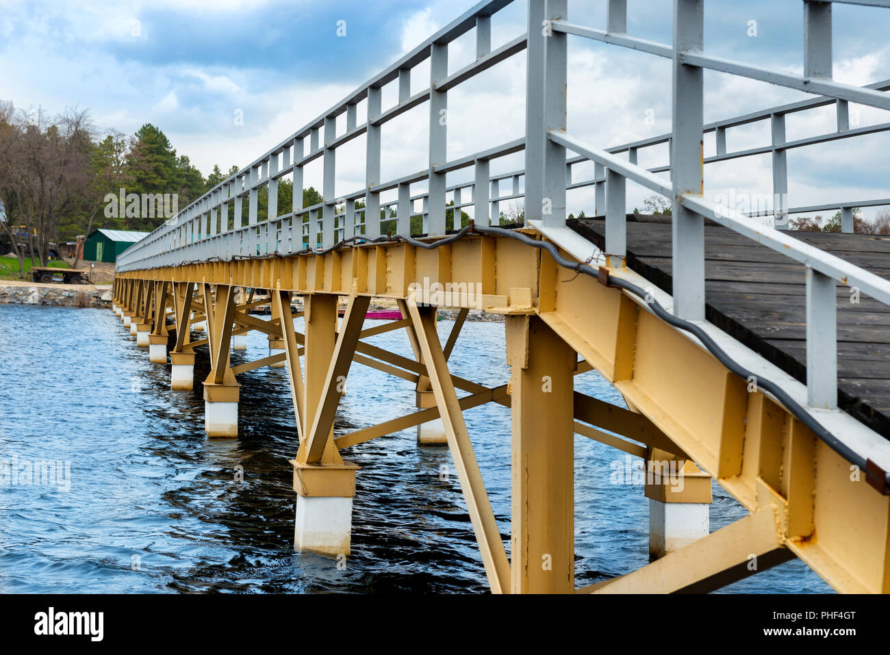 Steel bridge along river bank Stock Photo - Alamy