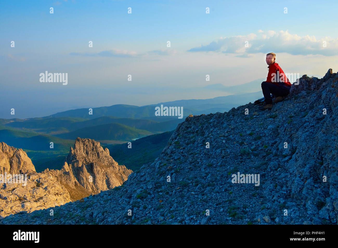 Man sitting on the rock Stock Photo - Alamy