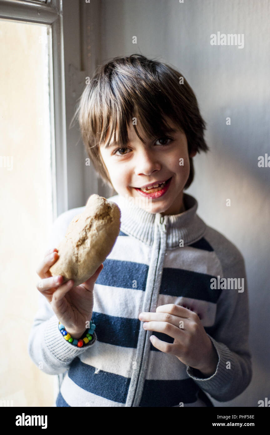 child eats big homemade bread Stock Photo - Alamy