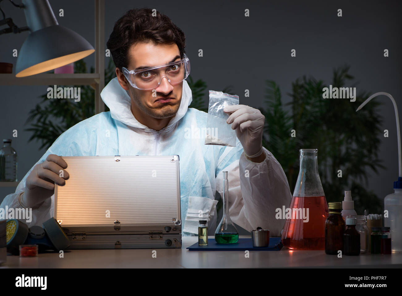 Forensic investigator working in lab looking for evidence Stock Photo ...