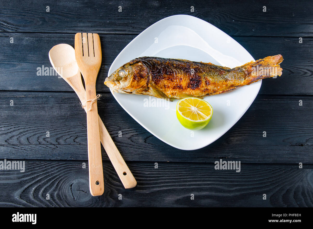 Fried fish served on the plate Stock Photo - Alamy