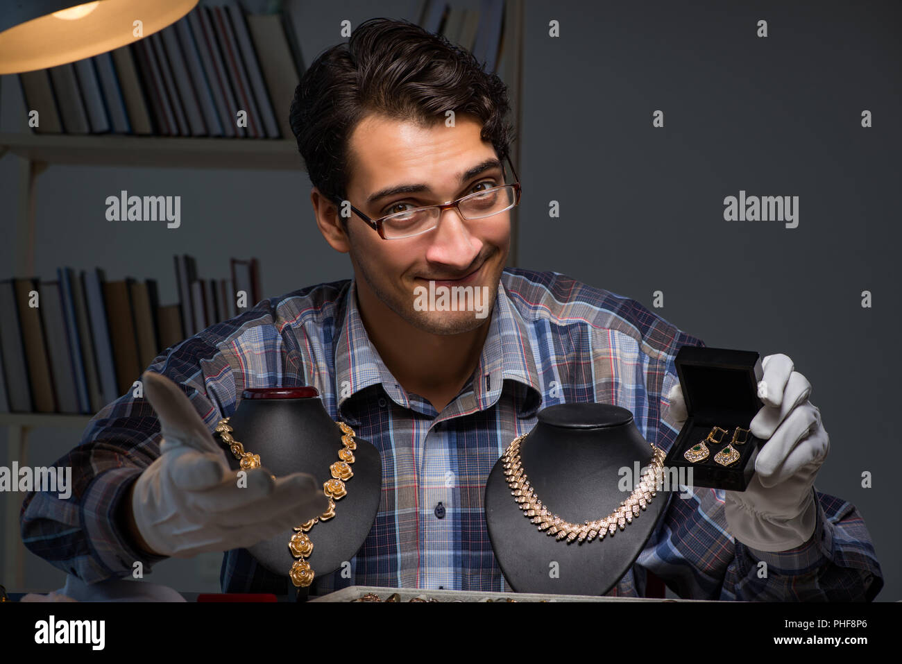 Young male jeweller working at night in his workshop Stock Photo - Alamy