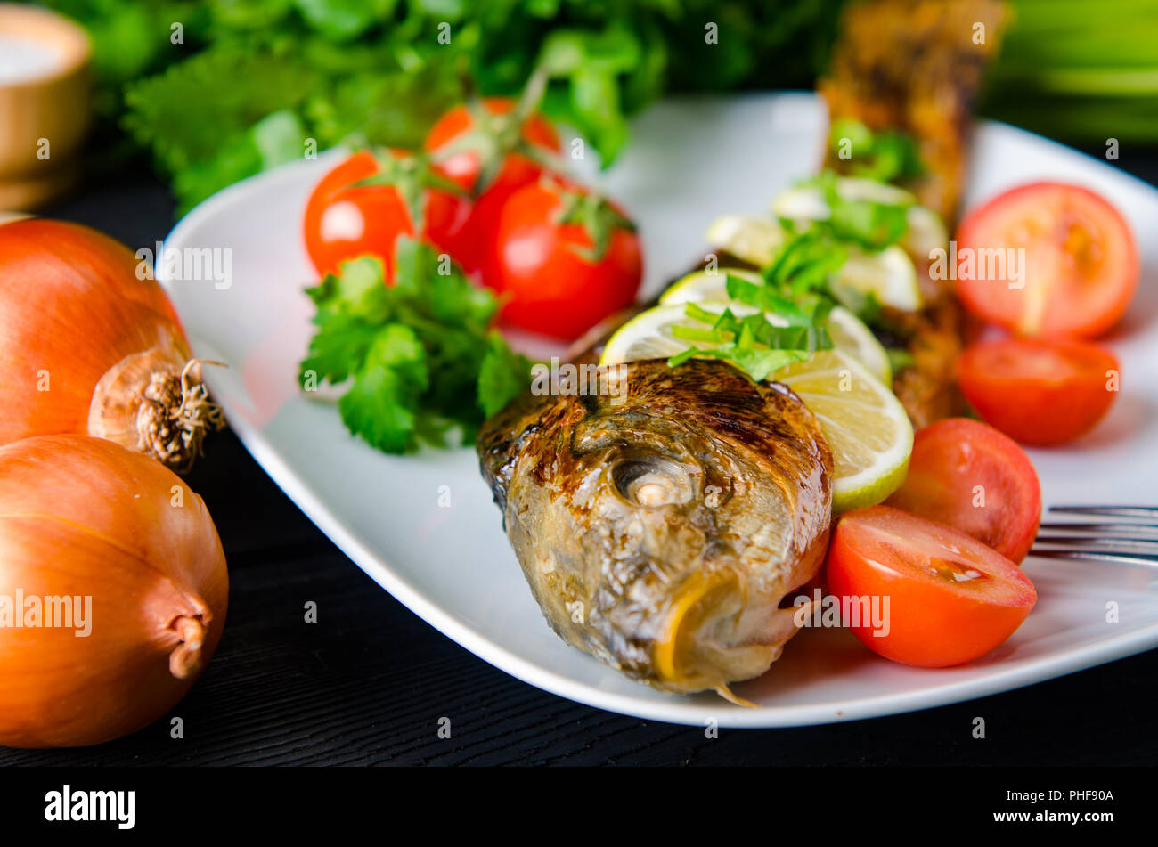 Fried fish served on the plate Stock Photo - Alamy