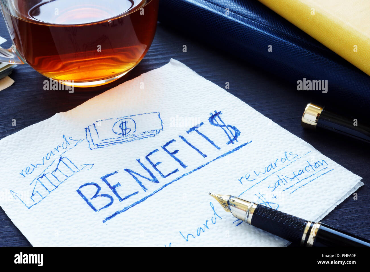 Benefits written on a napkin. Employee motivation Stock Photo - Alamy